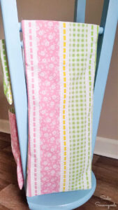Vertical Wrapping Paper Storage from a Wood Counter Stool